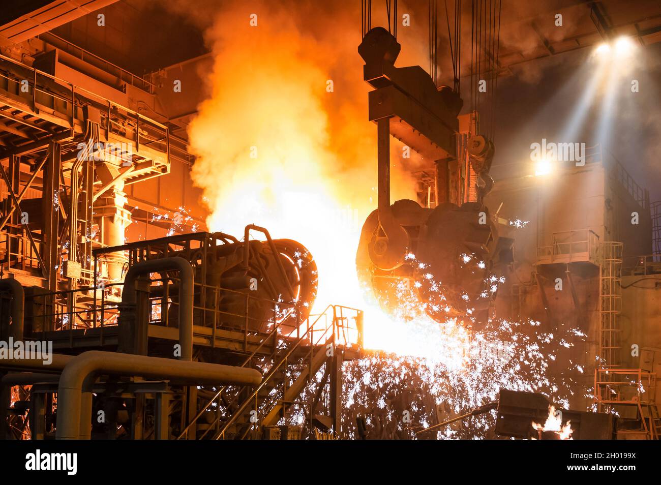 Pouring molten metal into a metallurgical electric arc furnace Stock ...