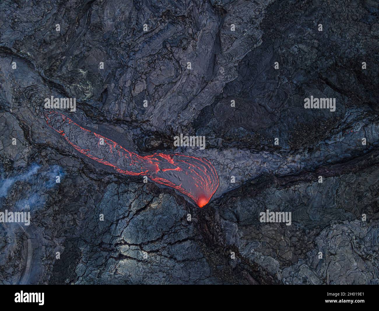 viewed from above on red-orange lava flow on cooled lava after volcanic ...