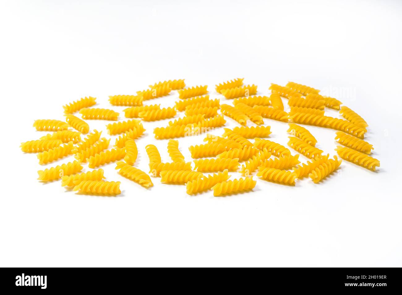 Raw Fusilli pasta, isolated on white background, selective focus ...