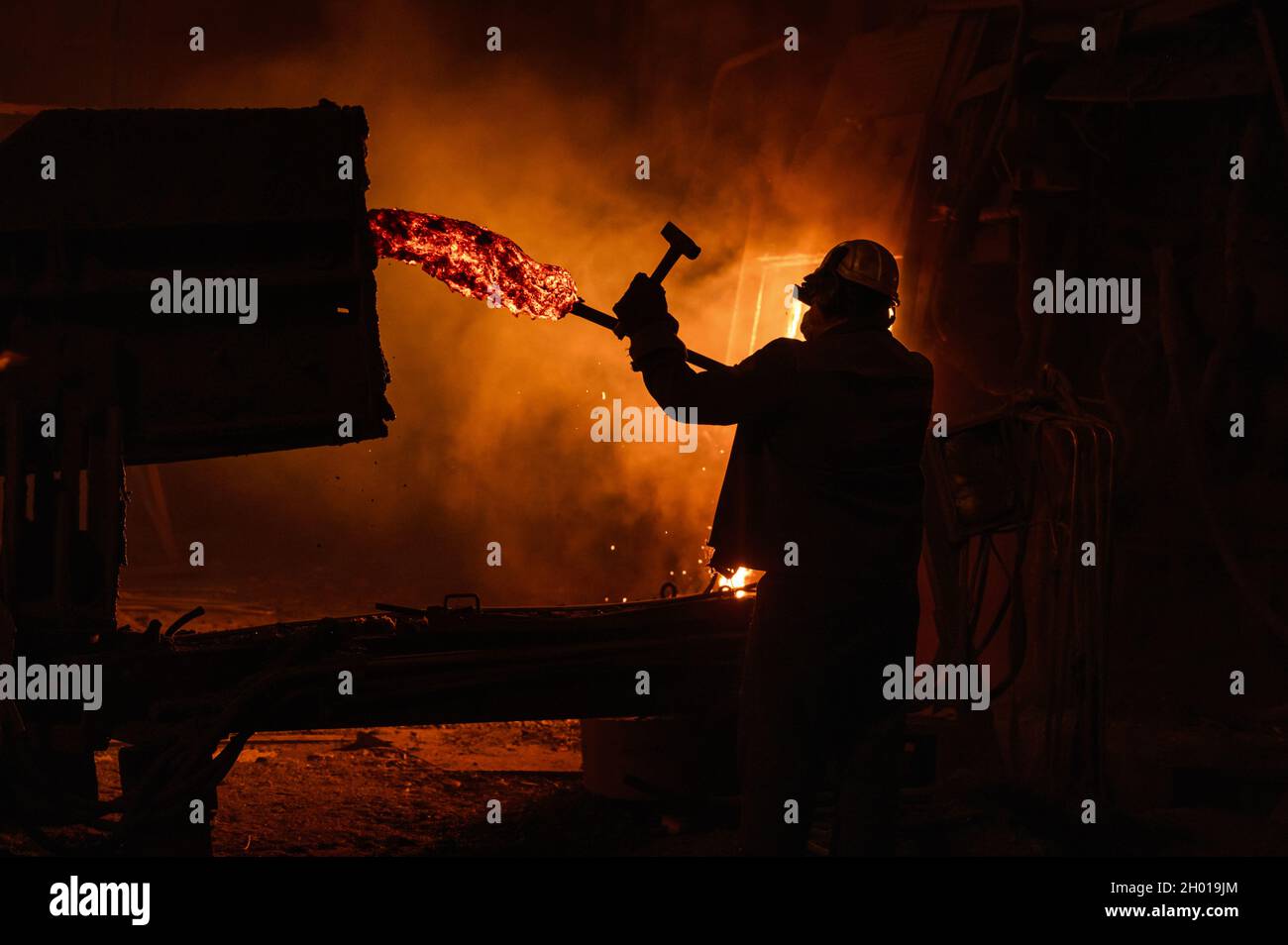 process of taking a sample of liquid metal in a steelmaking furnace ...