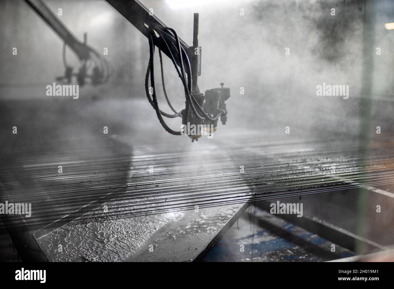 Conveyor for painting large sheets of metal. Lots of paint spray ...