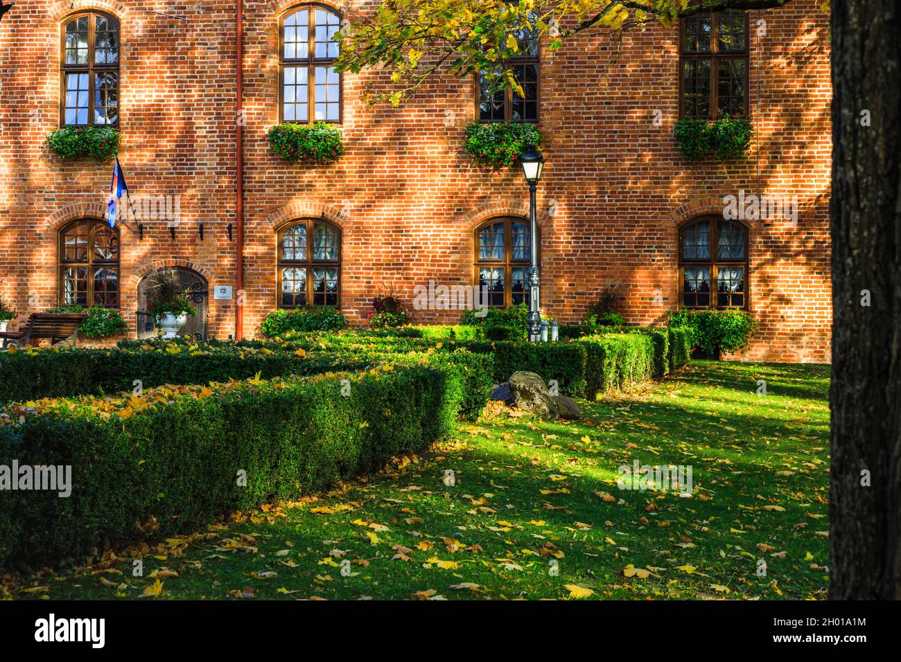 gothic-renaissance manor castle facade and garden on a sunny autumn ...