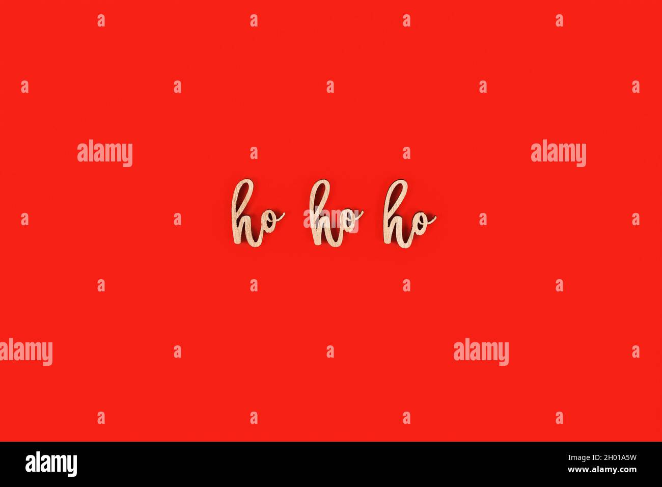 Seasonal Christmas wooden letters forming words 'ho ho ho' on red ...
