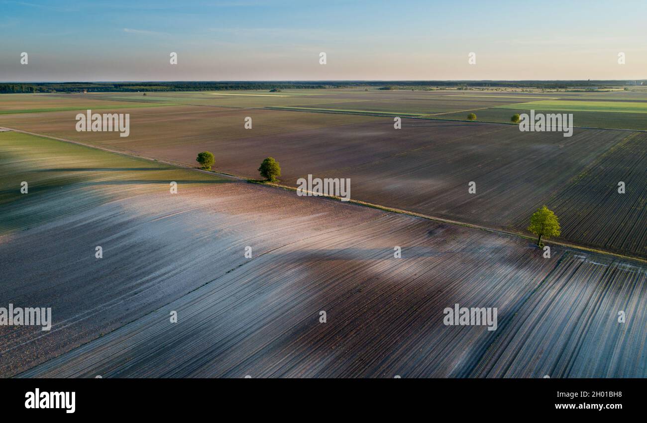 Aerial image of agricultural fields in plains in spring time shoot from ...