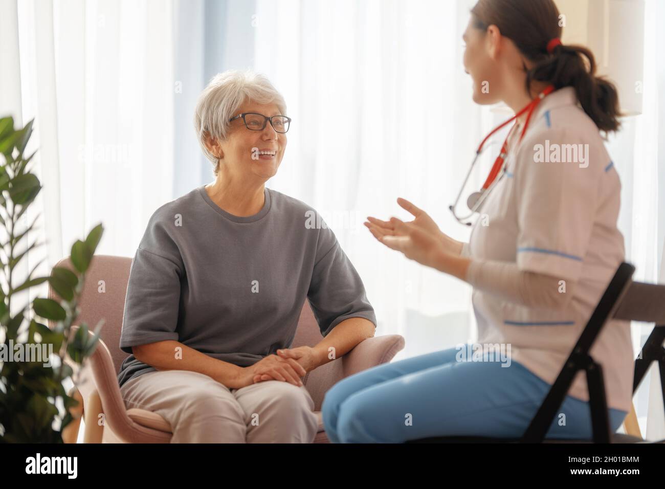 Female patient listening to a doctor in hospital Stock Photo - Alamy