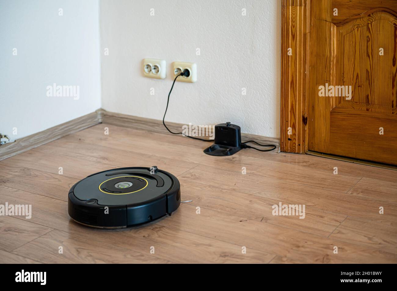 robot vacuum cleaner return to charging at dock in clean room floor ...