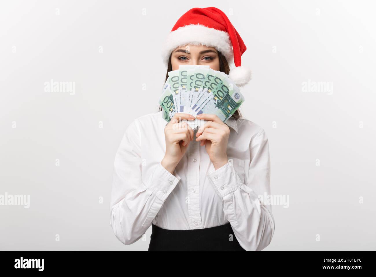 Christmas and finance concept - Young business woman showing money ...
