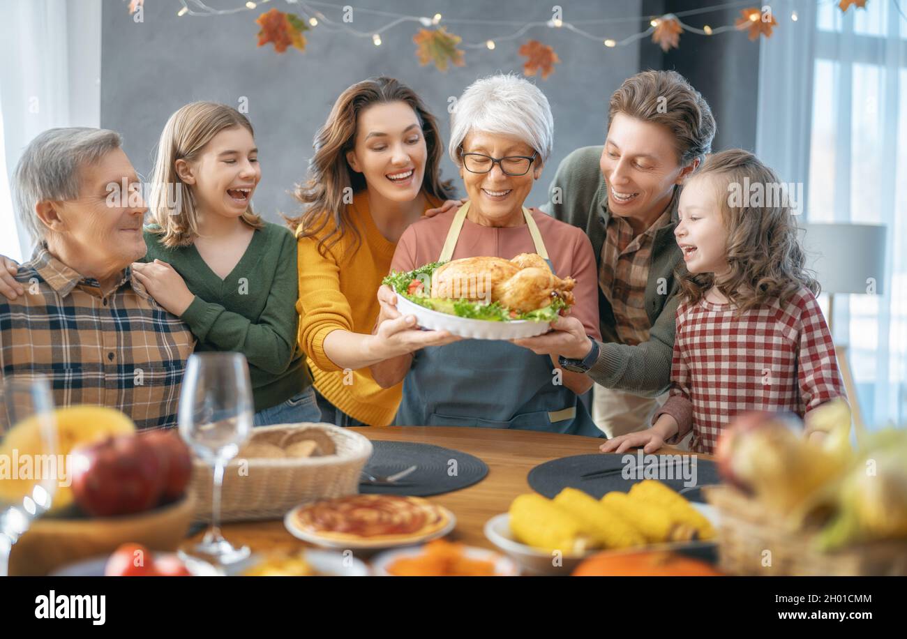 Thanksgiving Day, Autumn feast. Happy family sitting at the table and ...