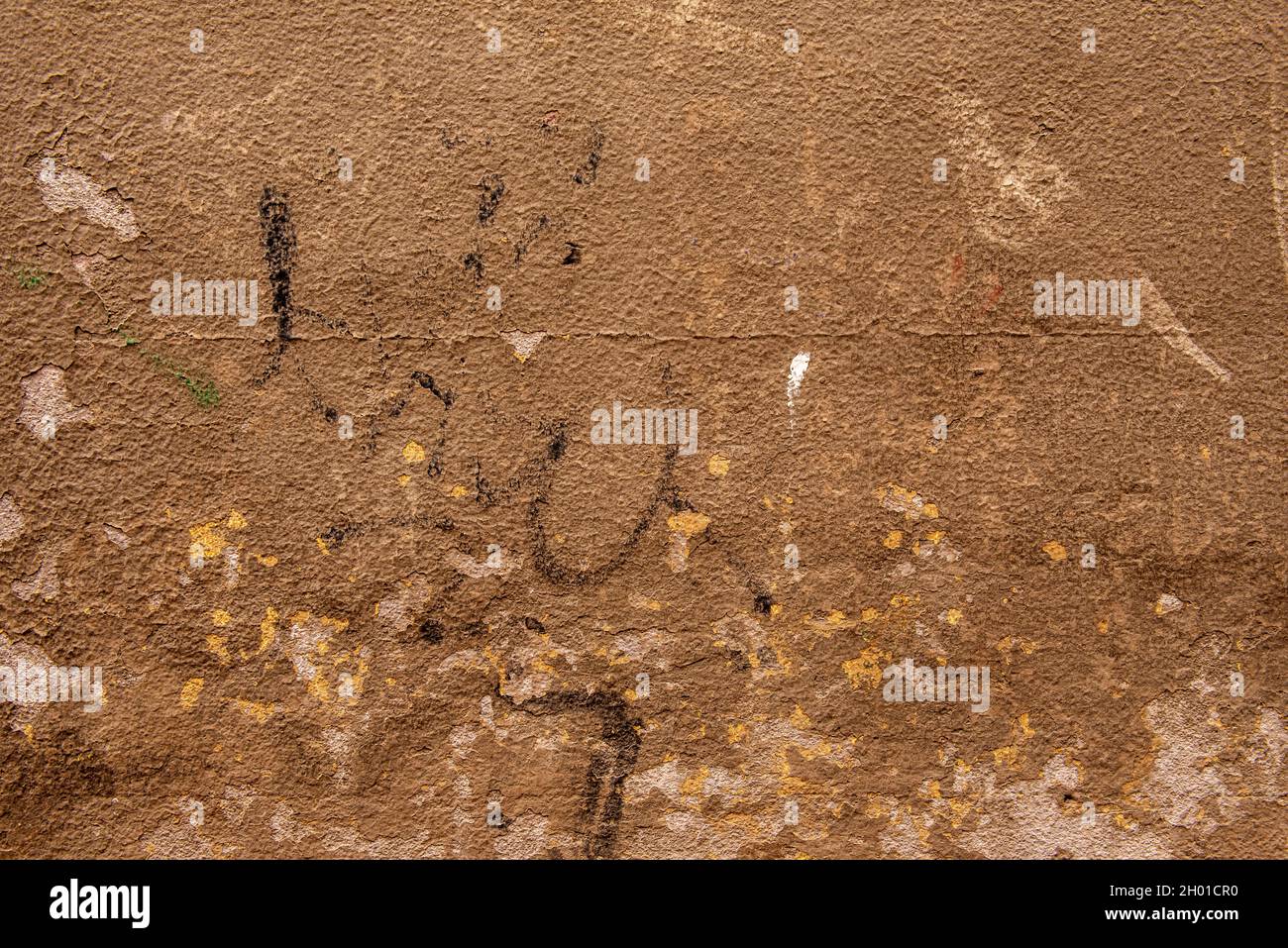 wall painted in ocher colors over and over again full of paint chips ...