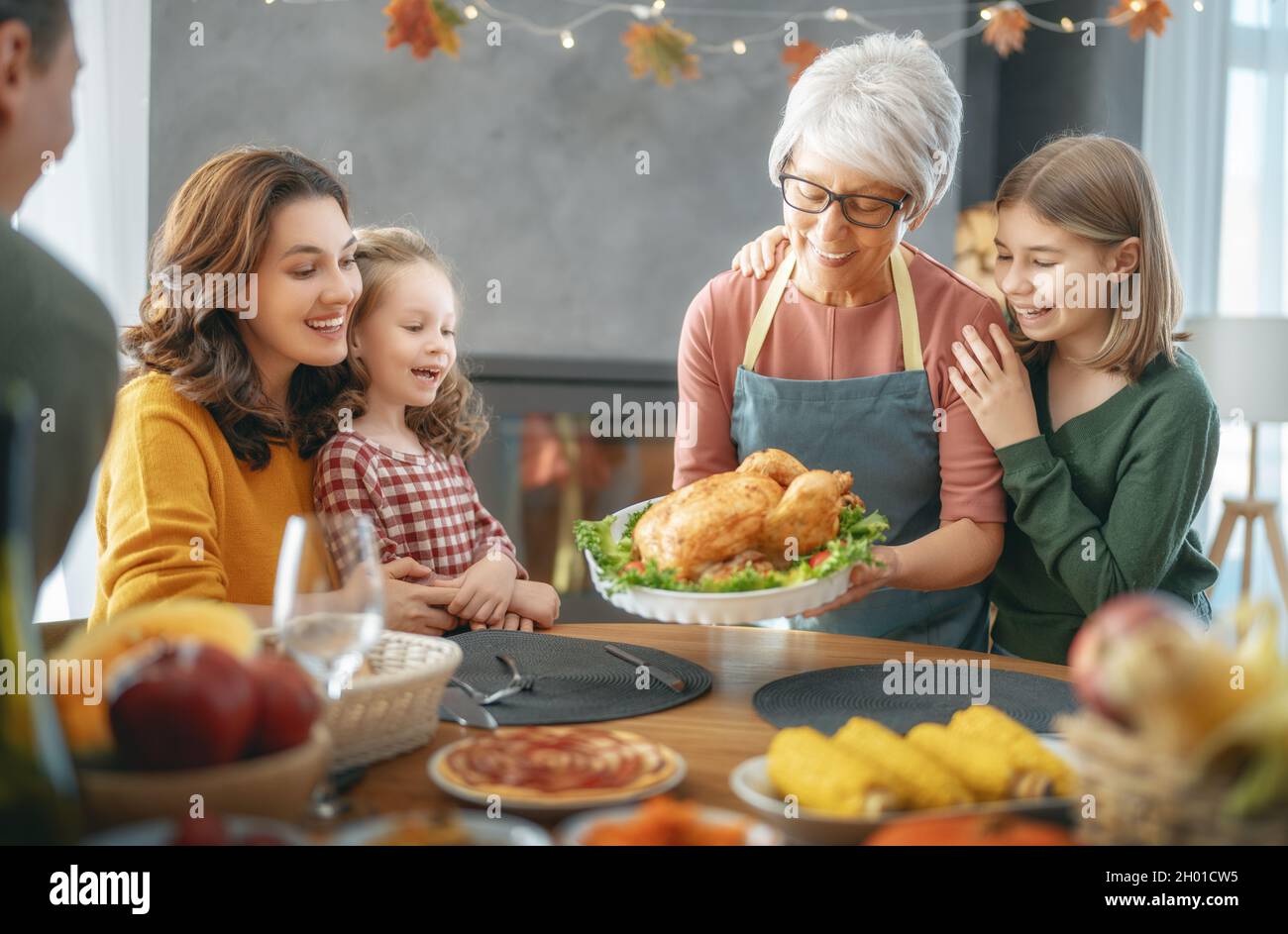 Thanksgiving Day, Autumn feast. Happy family sitting at the table and ...