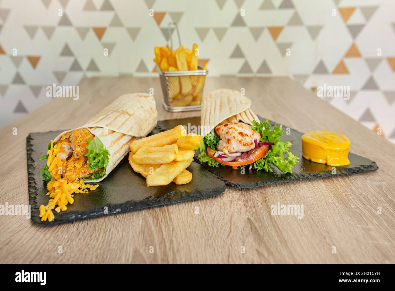 Assorted wrap stuffed with fried chicken in batter with vegetables and ...