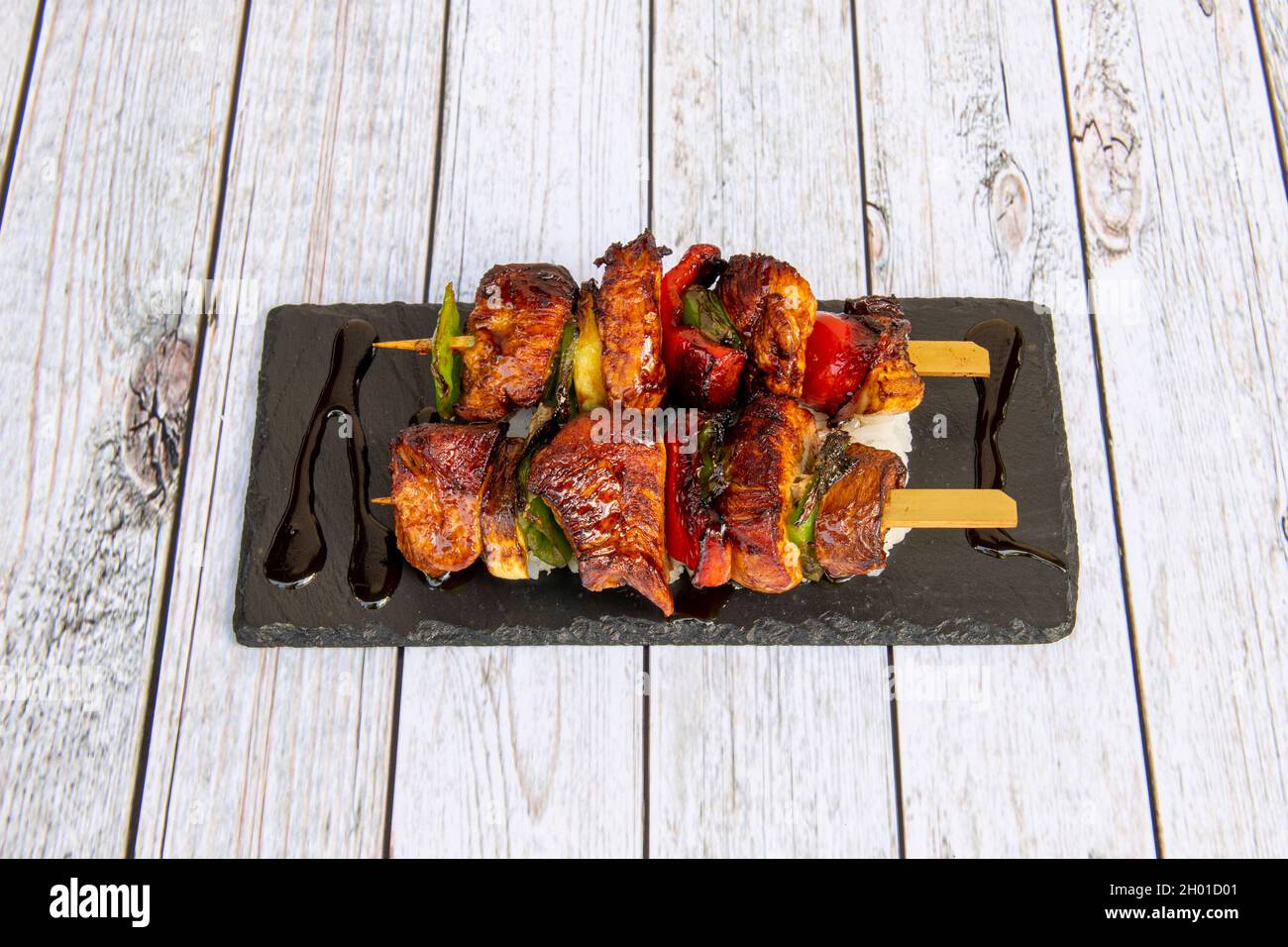 Vegetable chicken skewer, yakitori, with yakisoba sauce on a bed of ...