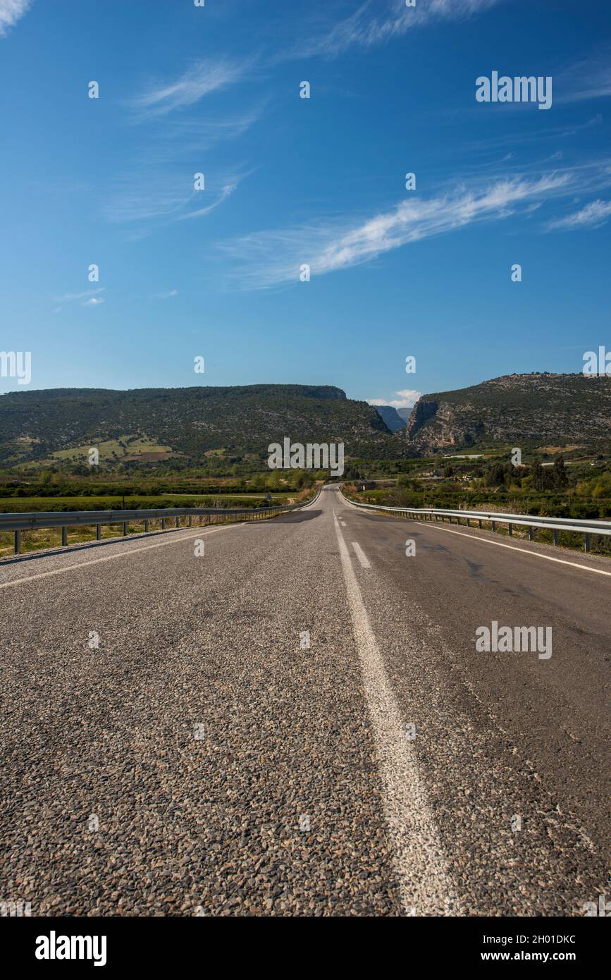 Road in the direction of a pass between mountains on a summer day Stock ...