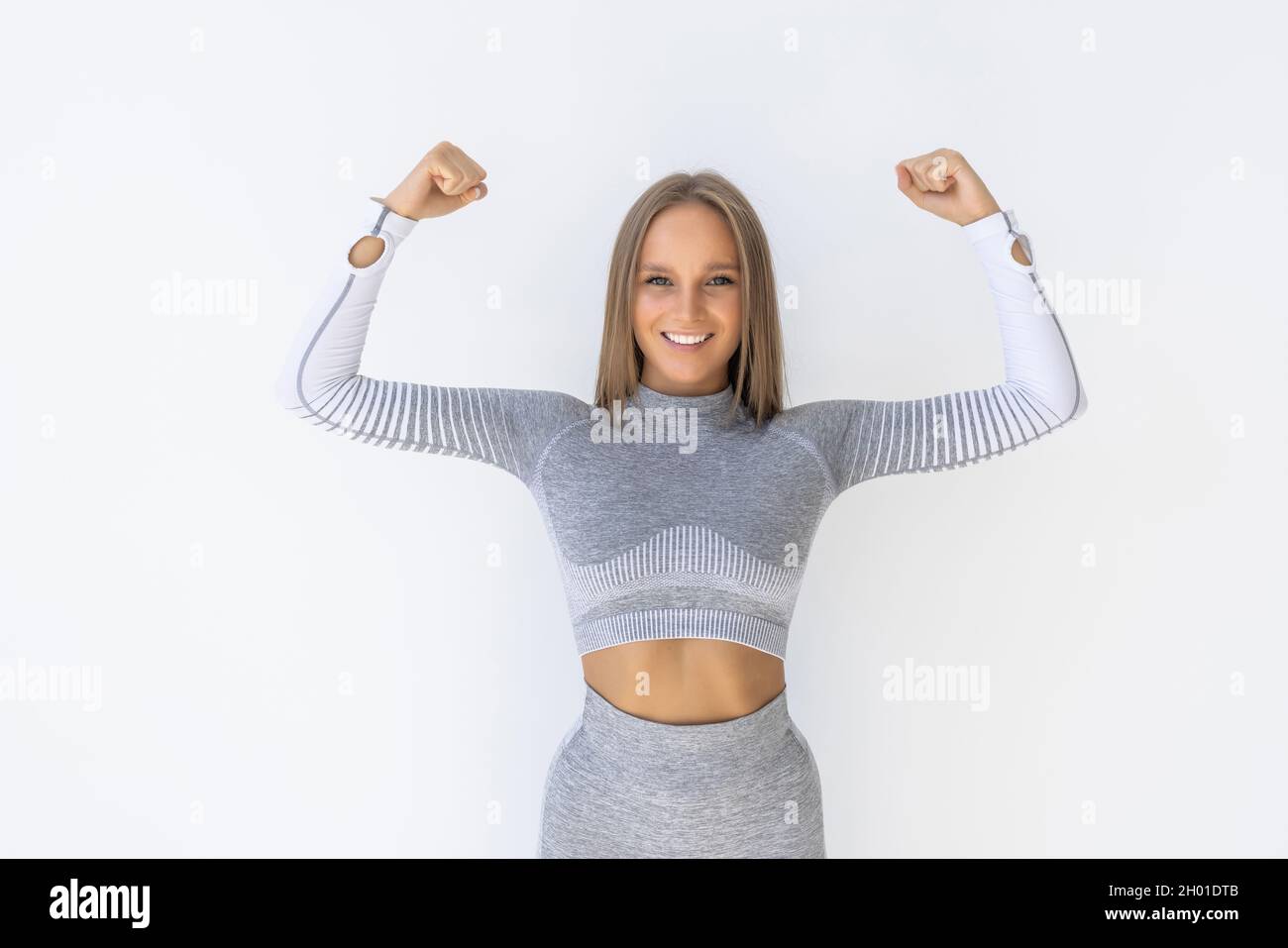 young woman strong gesture isolated on white background Stock Photo - Alamy