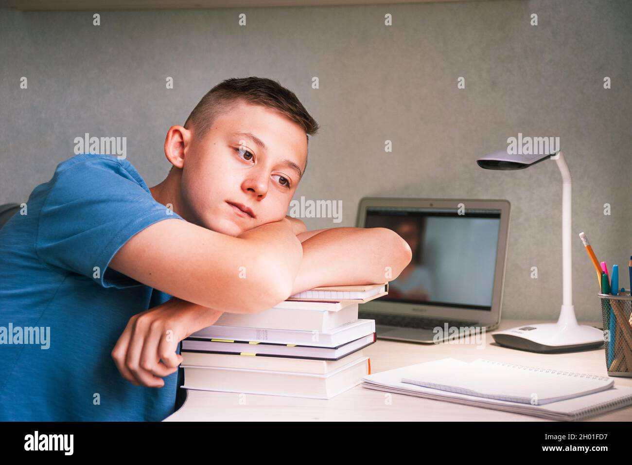 Teen boy napping on a stack of books Stock Photo - Alamy
