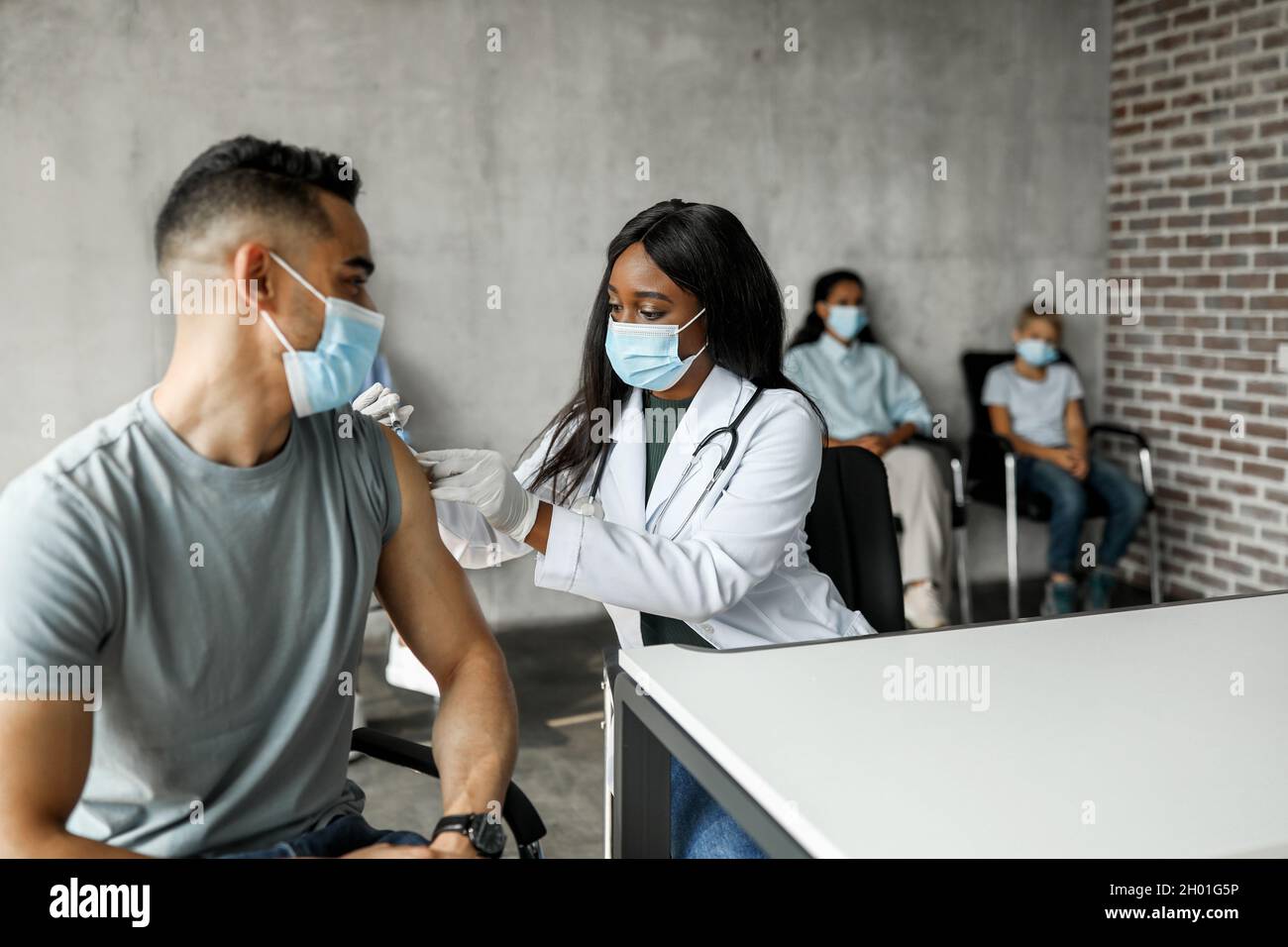 Arabic man patient getting intramuscular shot against COVID-19 at ...
