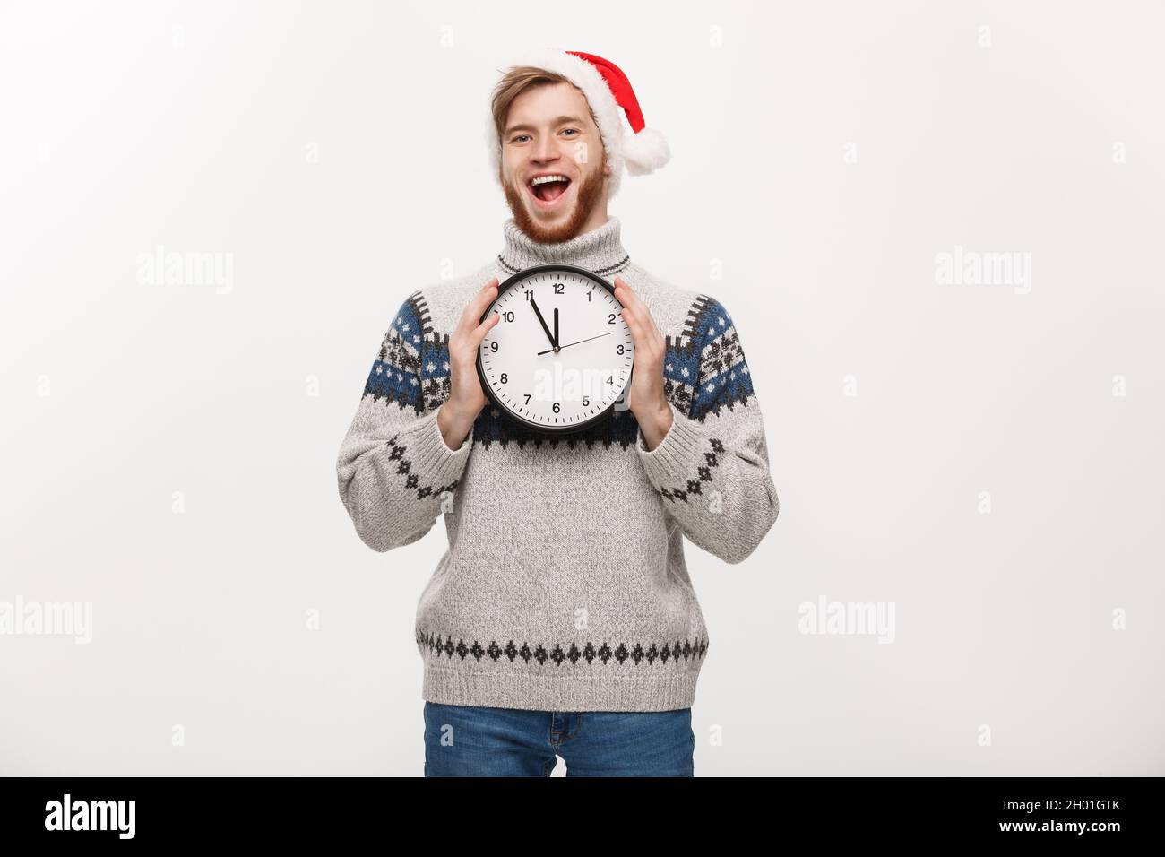 Holiday concept - Young happy handsome beard man in sweater holding ...
