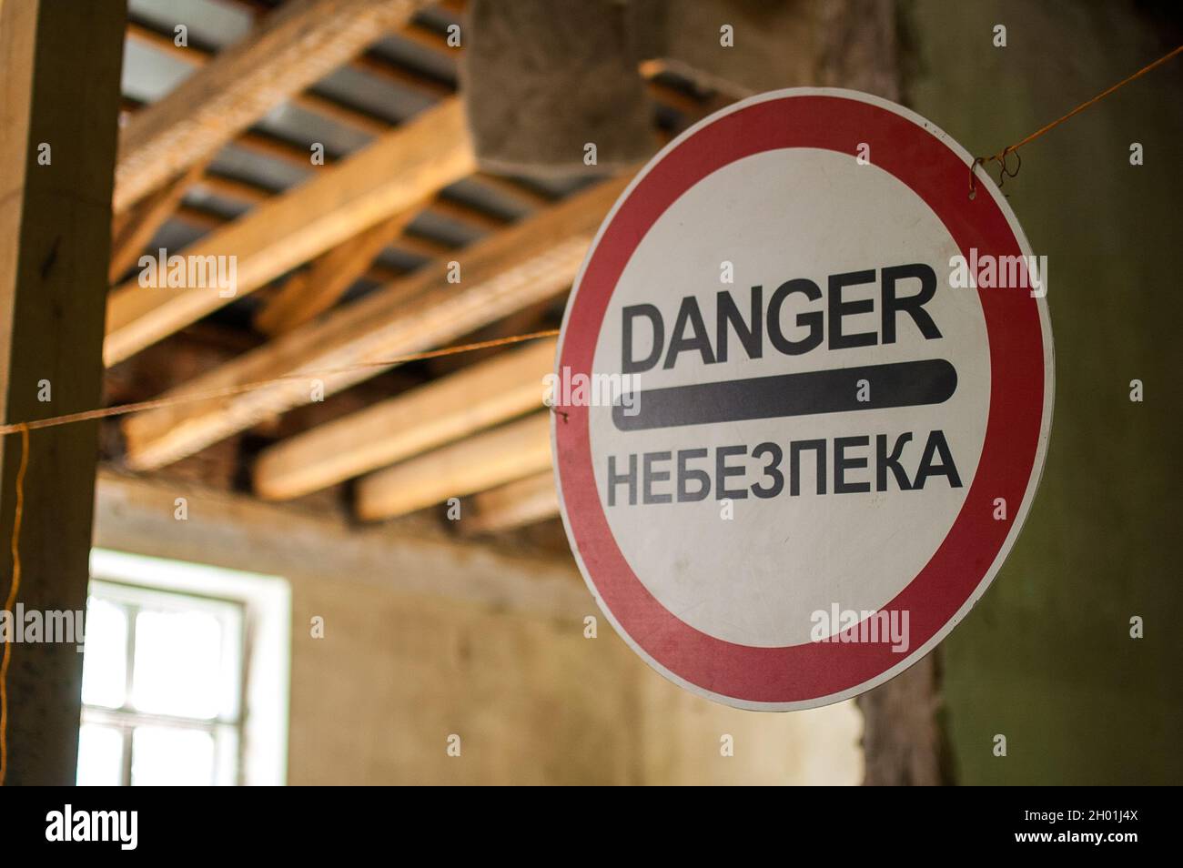 Old wrecked house with 'Danger' in English and in Ukrainian warning ...