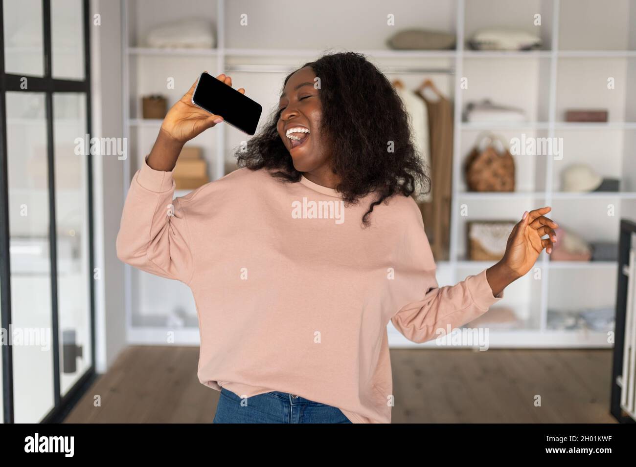 Black Female Singing Song Holding Smartphone Like Microphone Having Fun ...