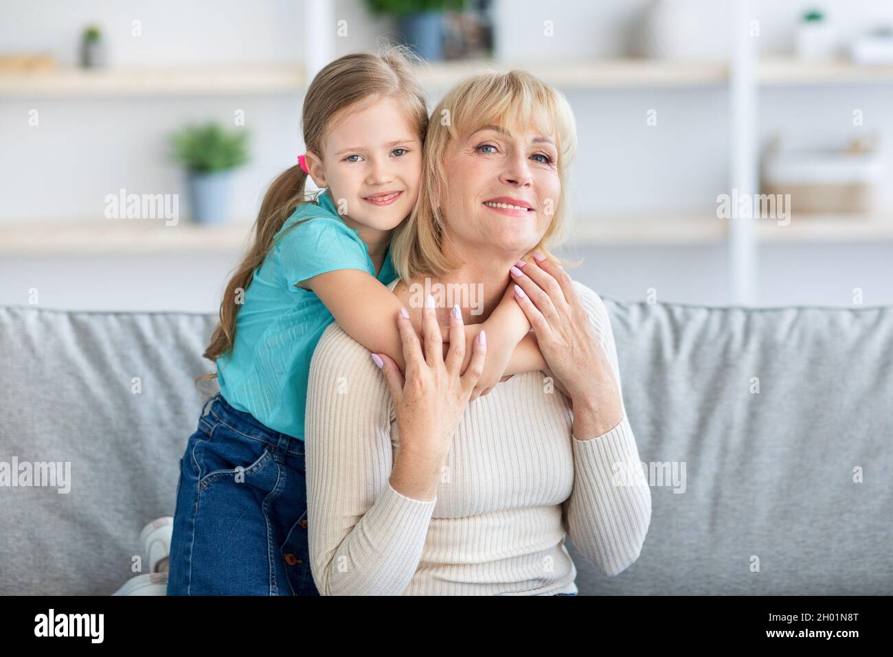 I Love You, Granny. Cheerful Little Girl Hugging Tight Her Grandmother ...