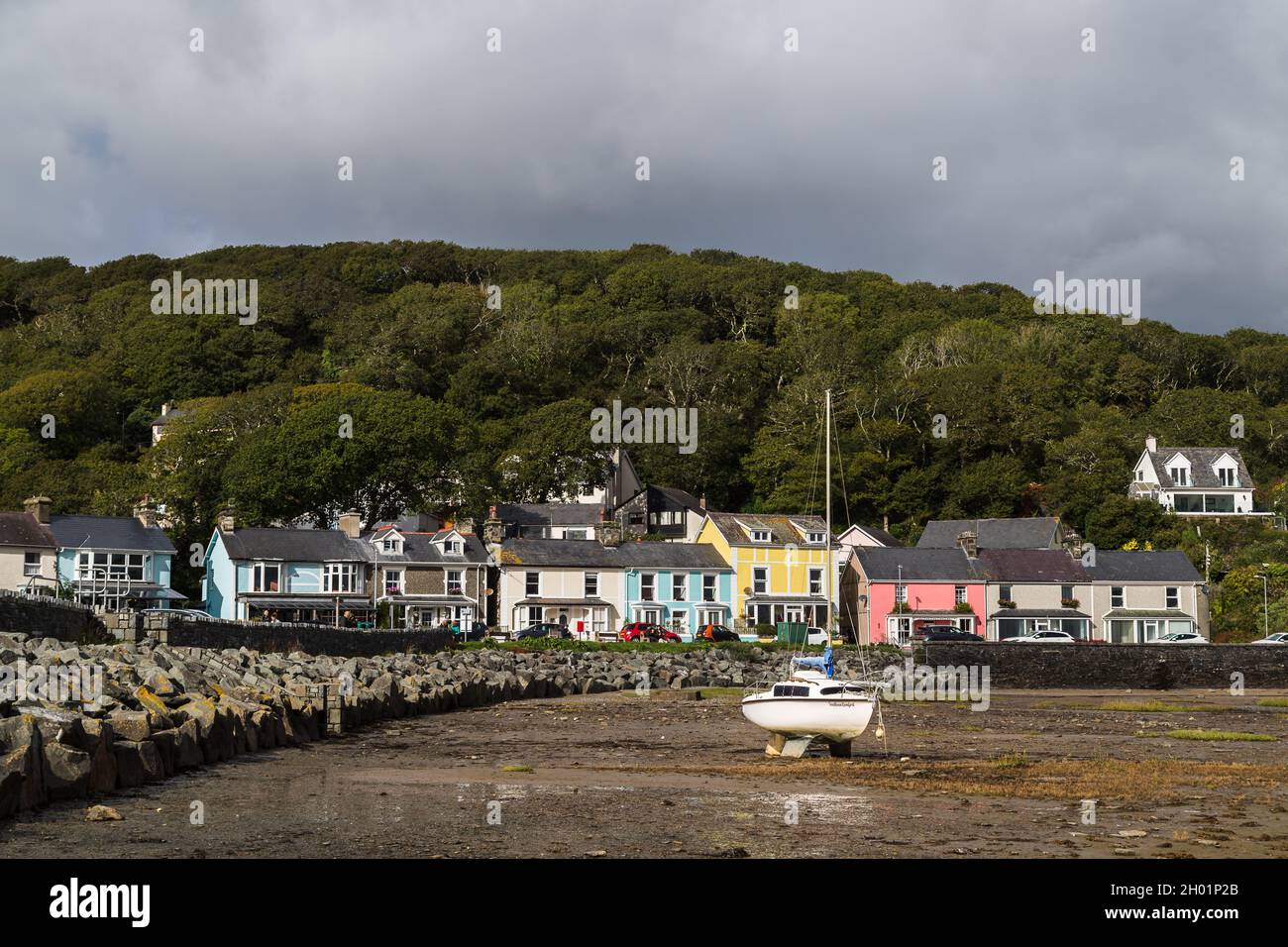 Colourful houses line the cove at Borth-y-Gest where small boats are ...