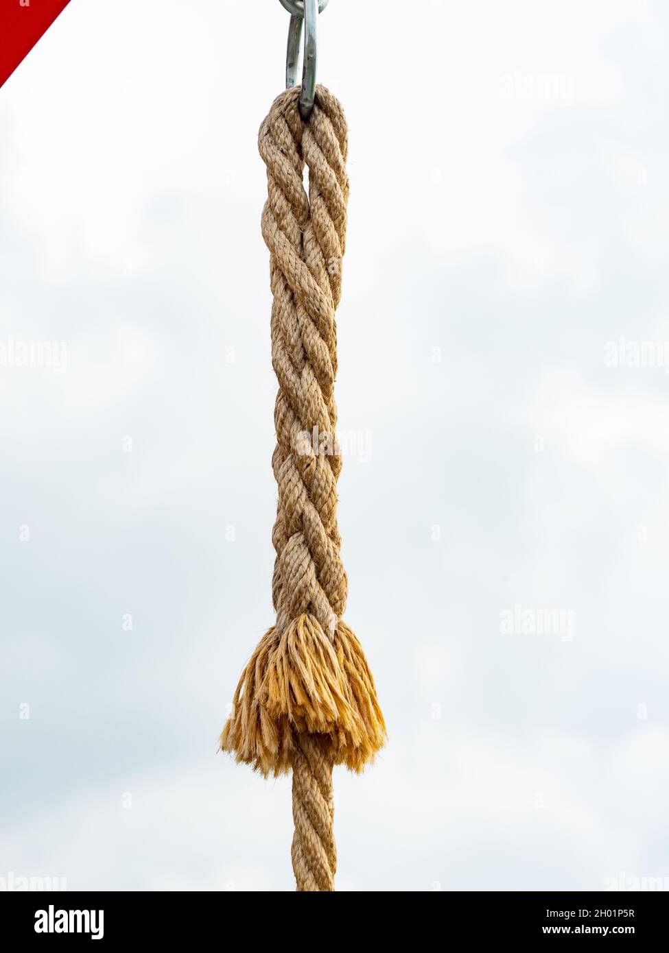 Climbing twisted rope ends with metal fastening on horizontal bar ...