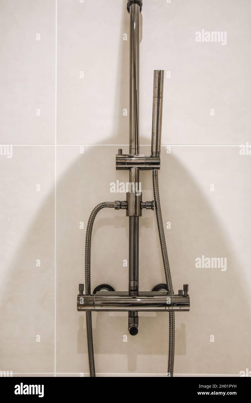 A vertical shot of a bathroom with white tiles on the walls Stock Photo ...