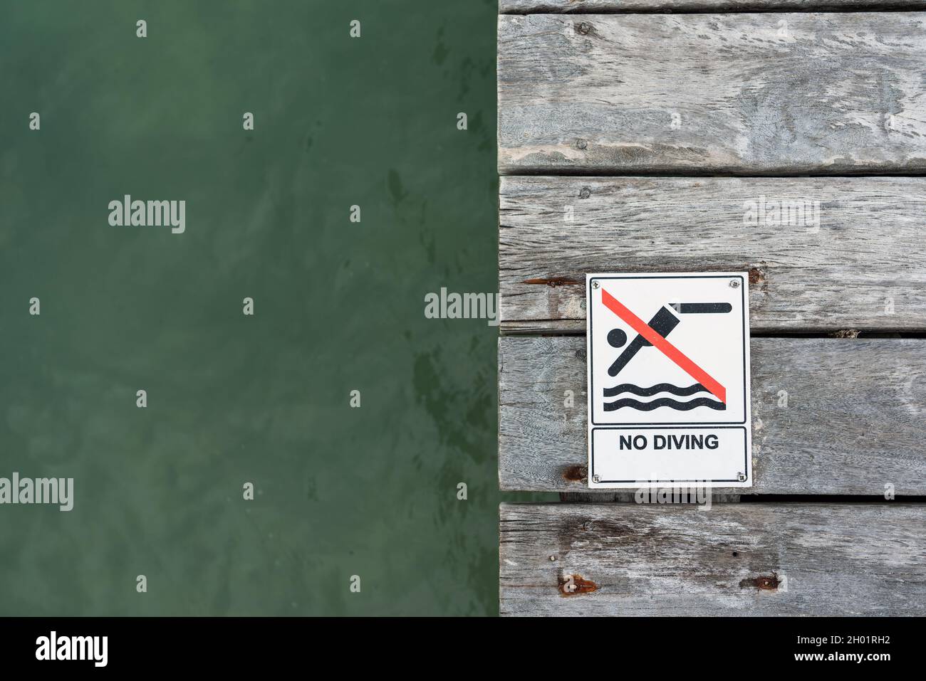 No Diving sign on a pier floor with ocean water in the background Stock ...