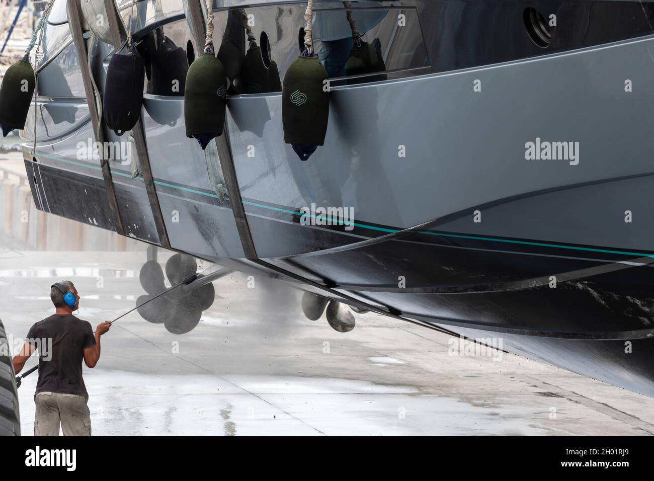 Yacht washing at the harbor Stock Photo - Alamy