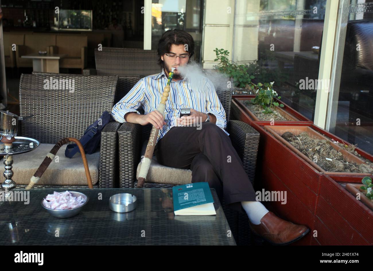 ISTANBUL, TURKEY - JANUARY 5: Young man smoke hookah (Nargile) on ...