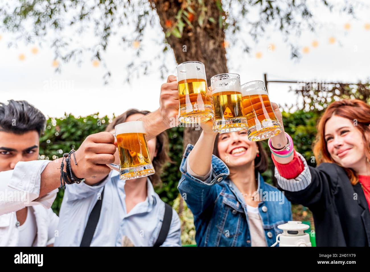 group of friends having fun at garden home party - Young people smiling ...