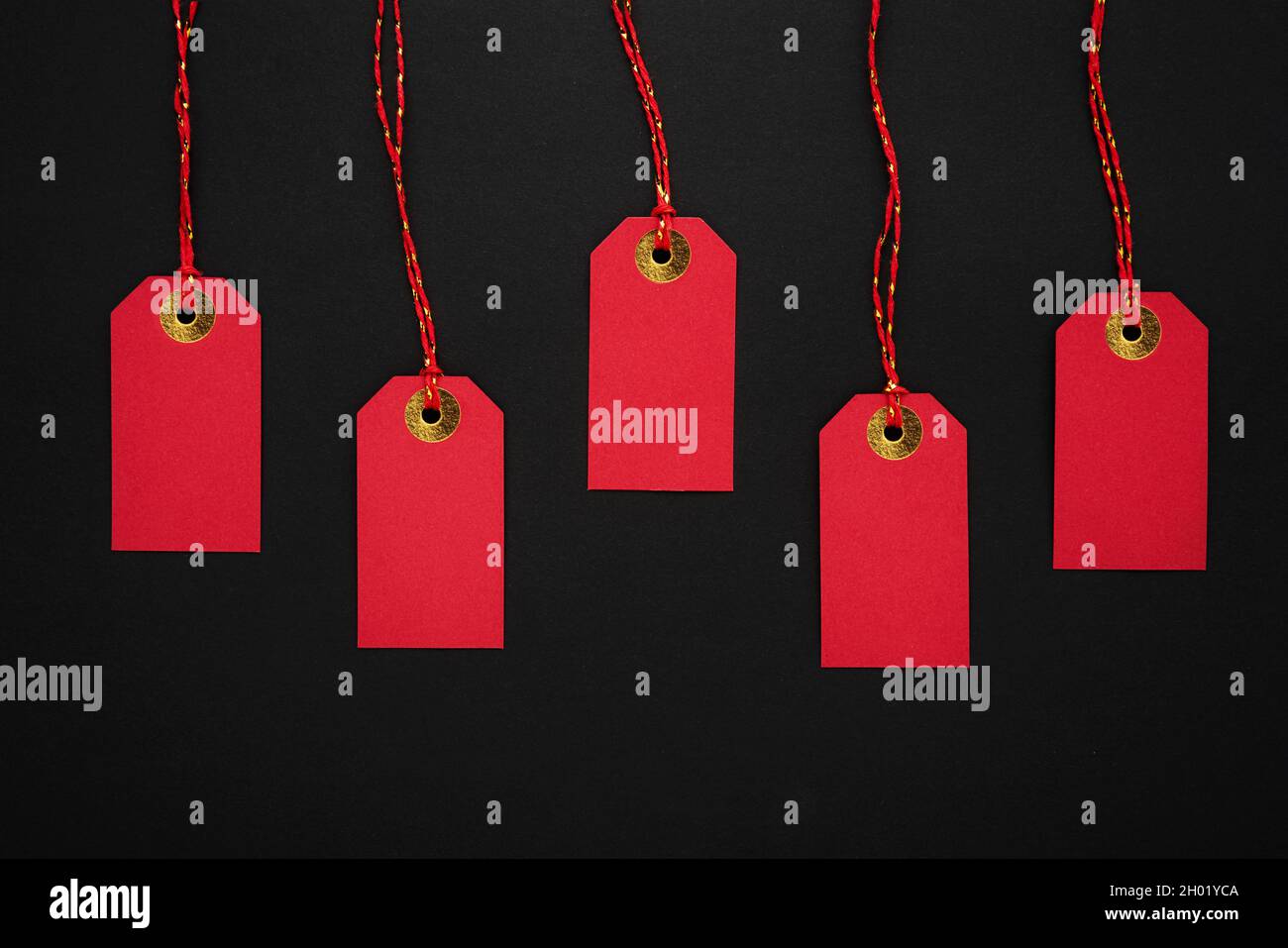 Red sale tags on a black background. Discounts and Black Friday concept ...