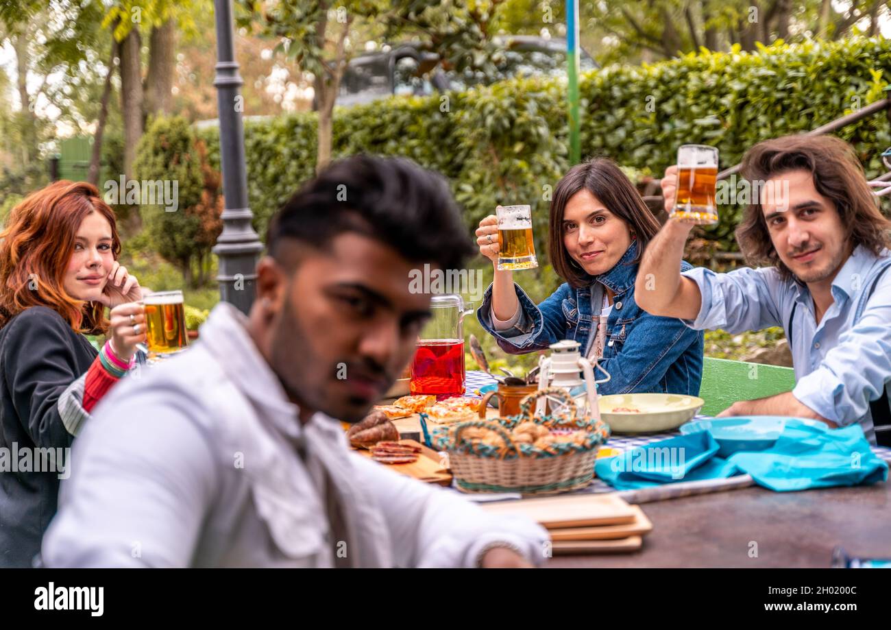 group of multi-cultural friends having fun at garden party - Young ...