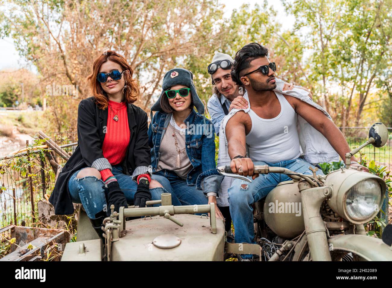 group of best friends together have fun riding a vintage motorcycle ...