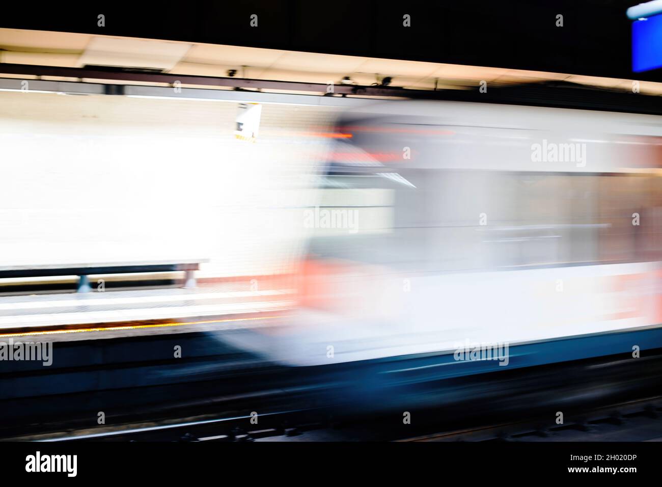 Defocused view of metro train arrival in station platform with no ...