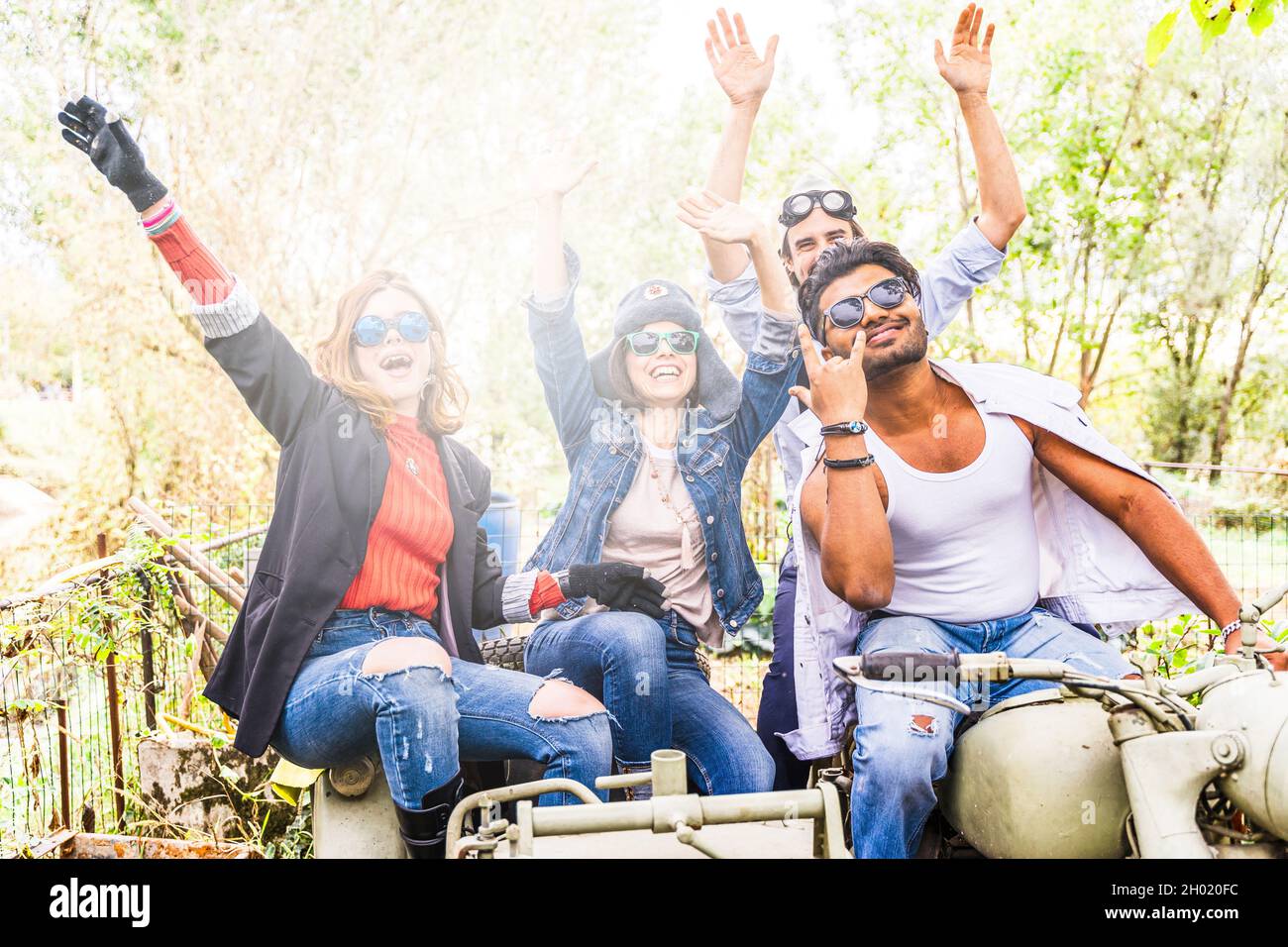 group of best friends together have fun riding a vintage motorcycle ...