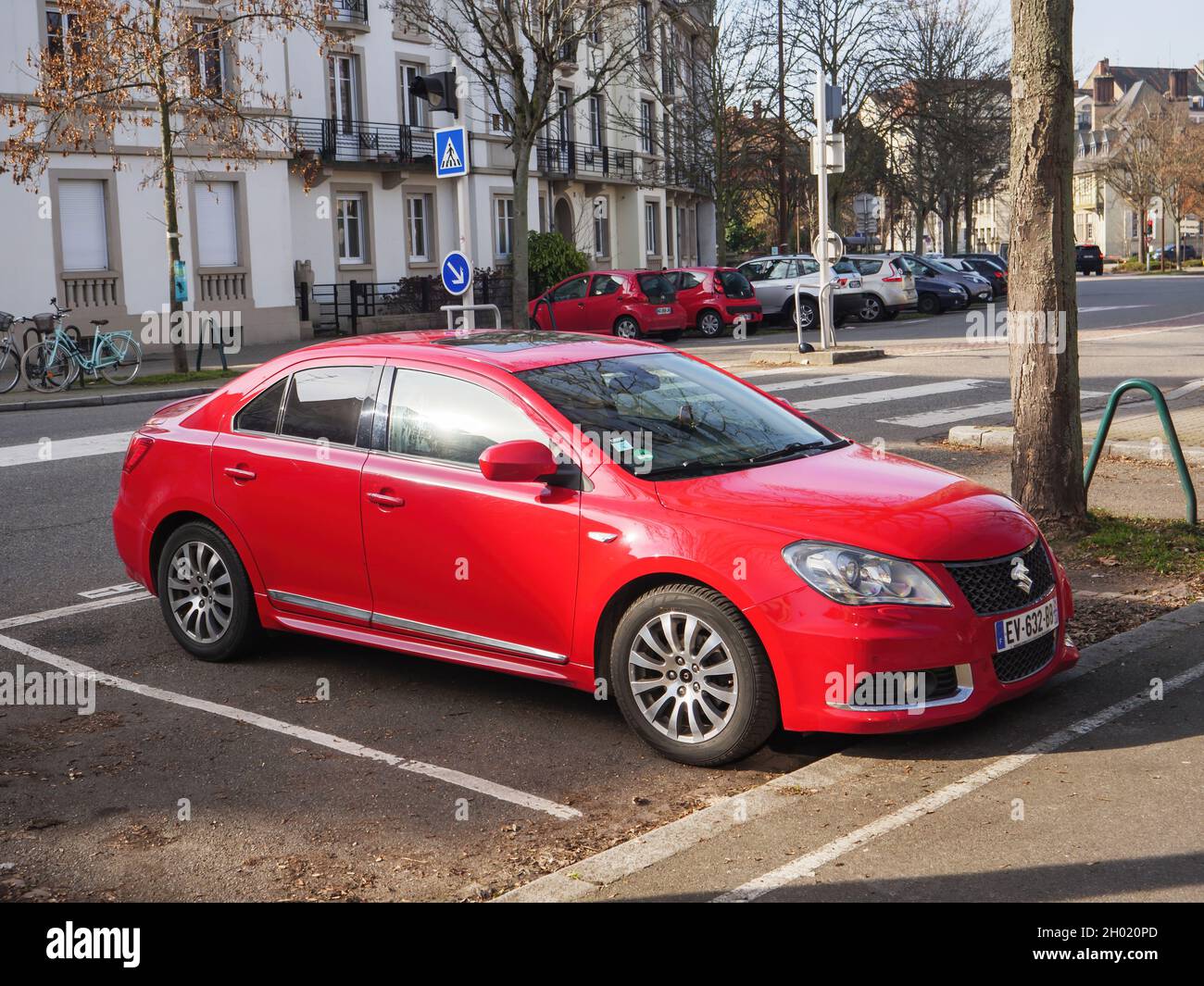 Side view of red Suzuki car parked on street in French city Stock Photo ...