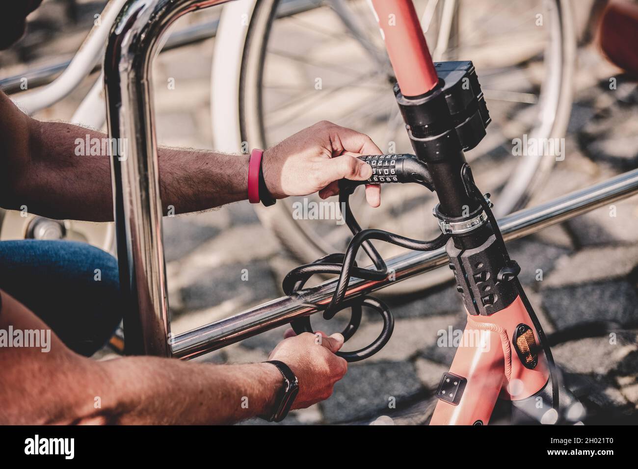 User safely parking electric scooter and locking it to a fence. Eco ...