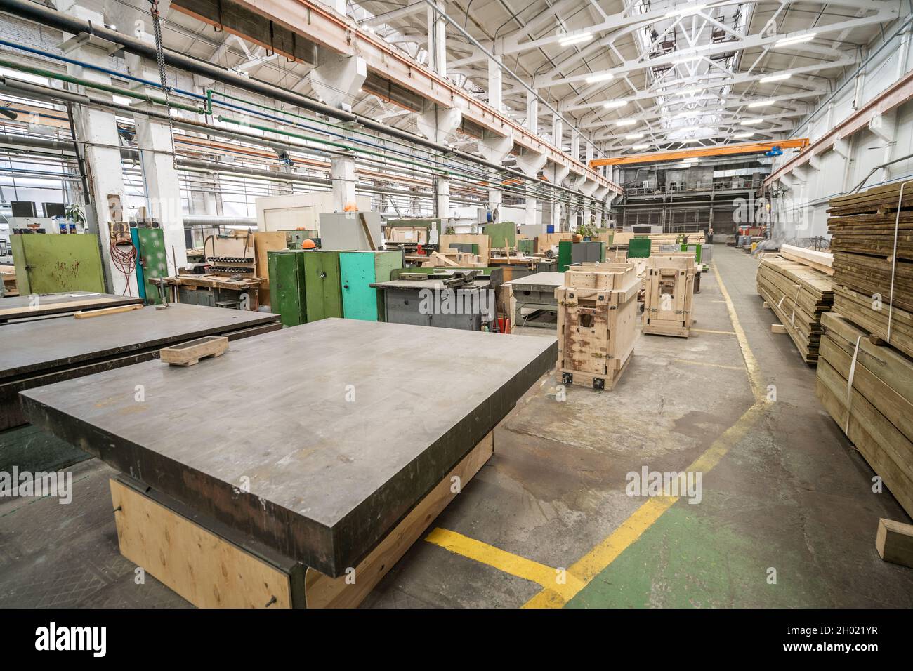 Inside interior factory workshop with stacks of wood for making molds ...
