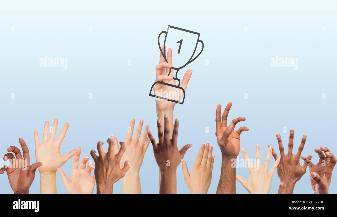 Hand of young european man with winner's cup, trophy and many ...