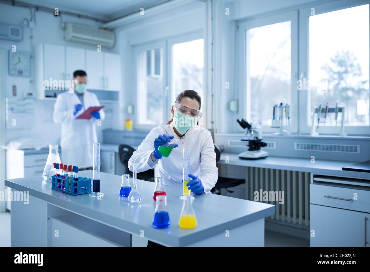 Biologists working on chemical research in laboratory Stock Photo - Alamy