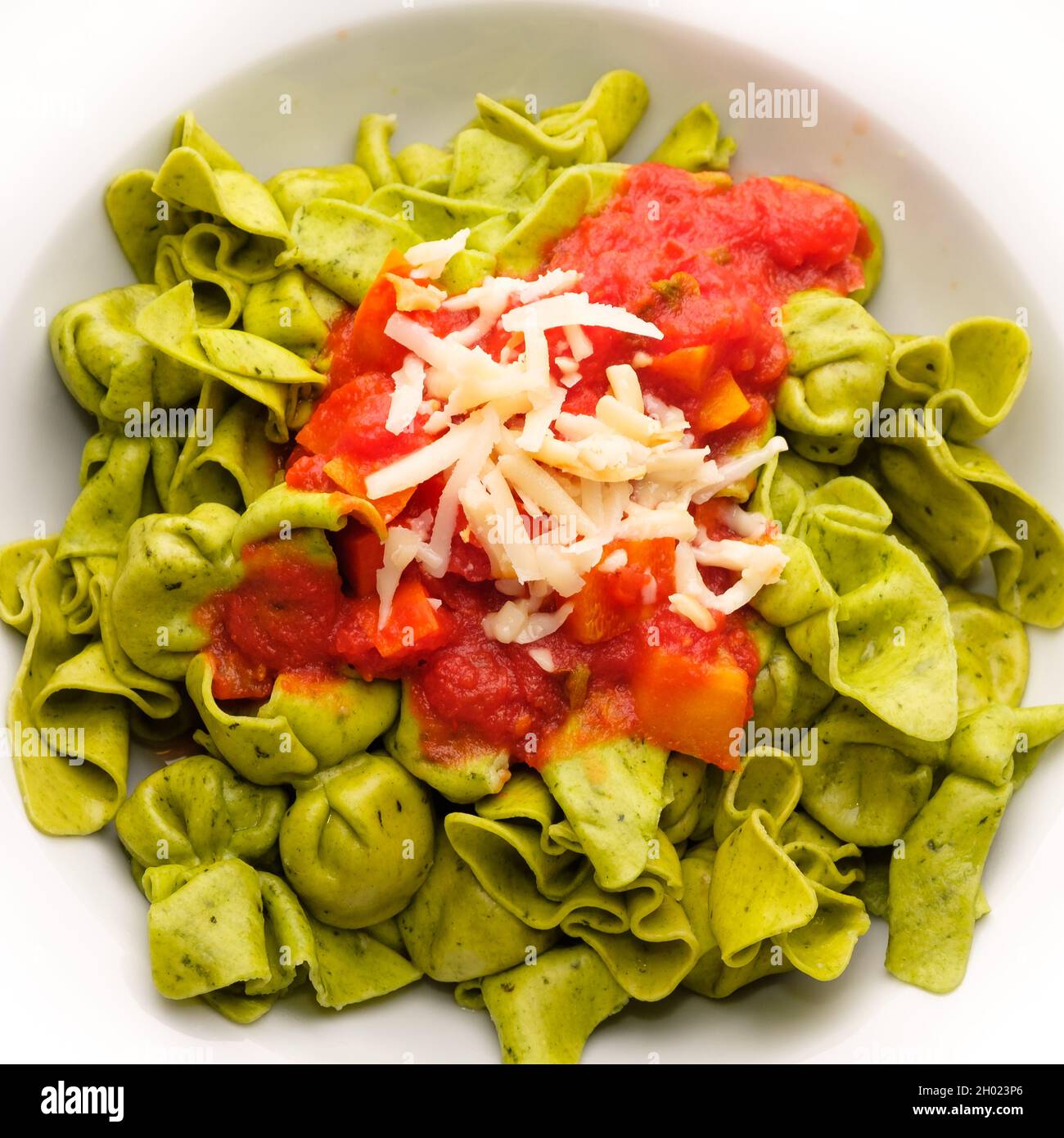 A top view of green fagottini pasta with scamorza cheese Stock Photo ...