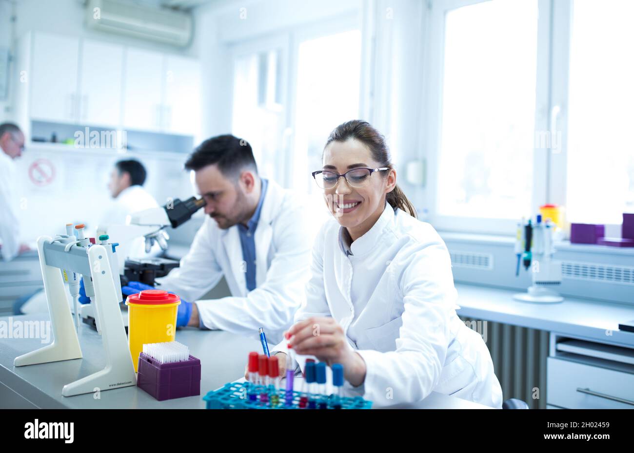 Team of experienced biologists working on samples in laboratory Stock ...