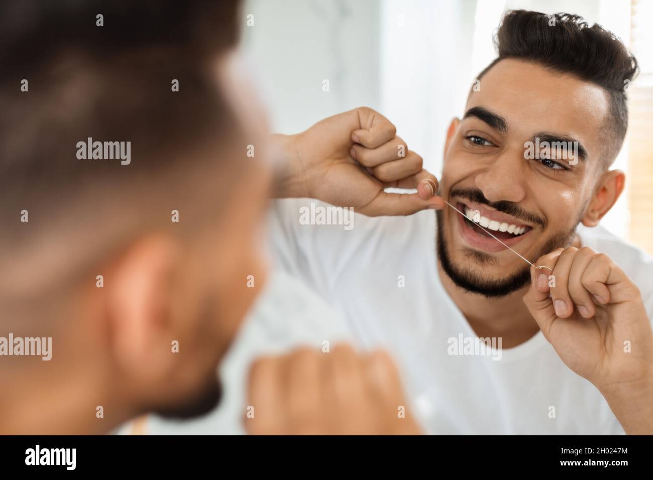 Oral Hygiene Concept. Handsome Arab Guy Using Dental Floss While ...