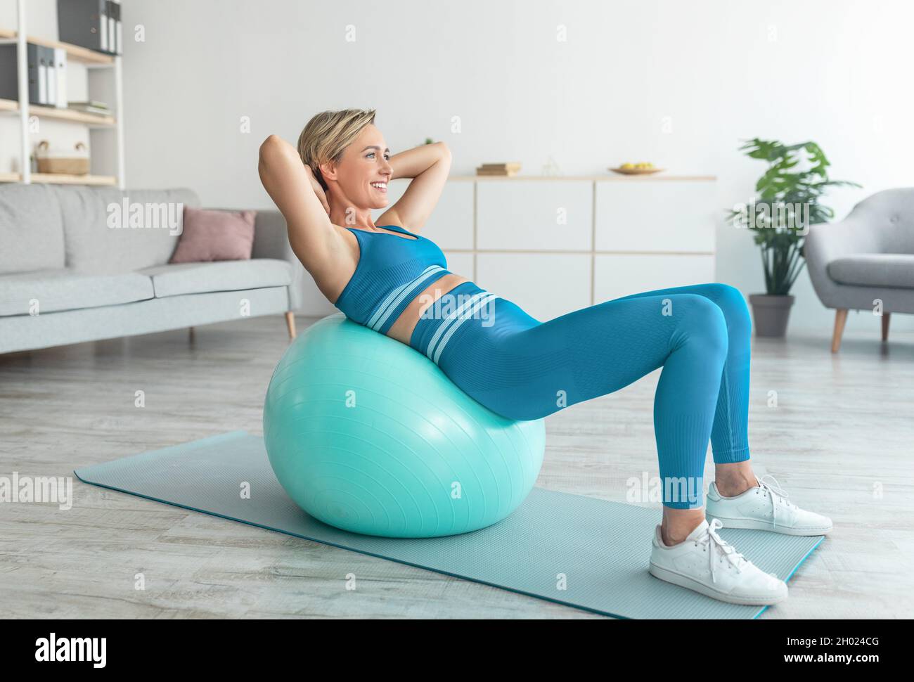 Stability And Balance Training. Smiling sporty woman doing abs ...