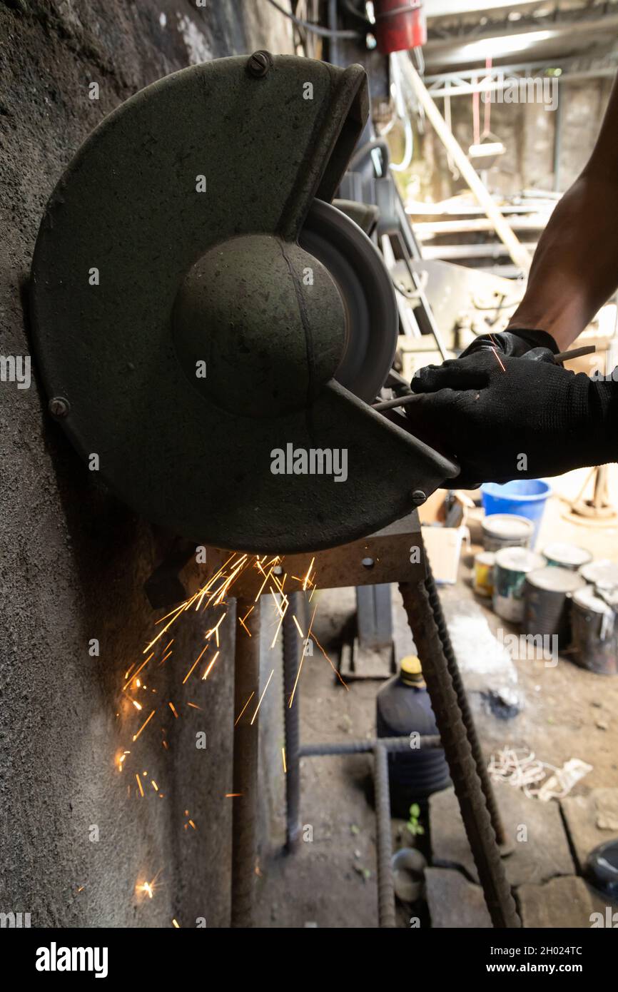 machinery in factory, detail of hands while working manually with work ...