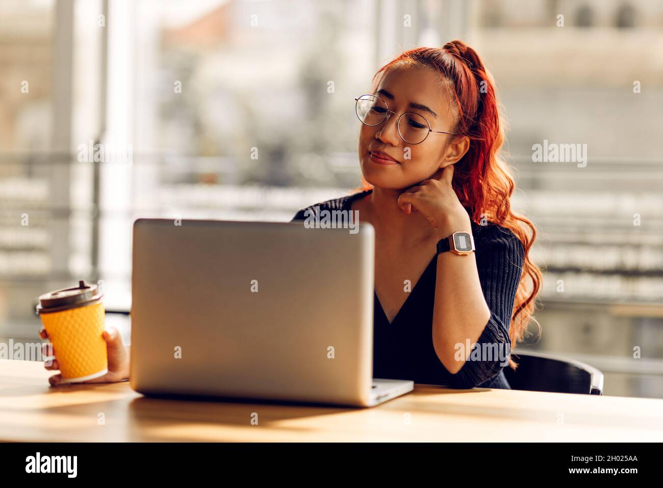 korean business woman wearing glasses using laptop in casual clothes ...
