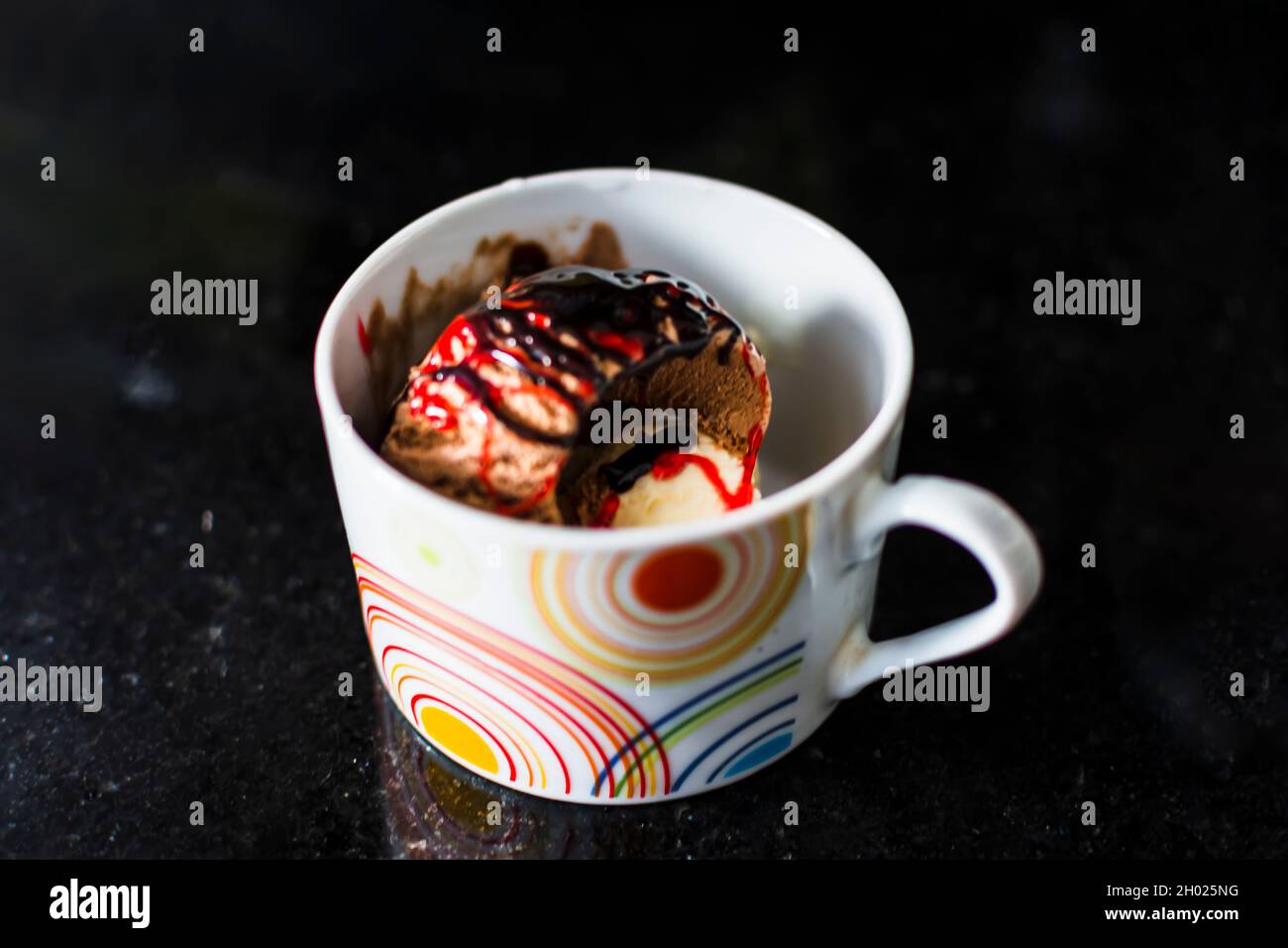 Delicious ice cream with cream, raisins and chocolate chips in the cup ...