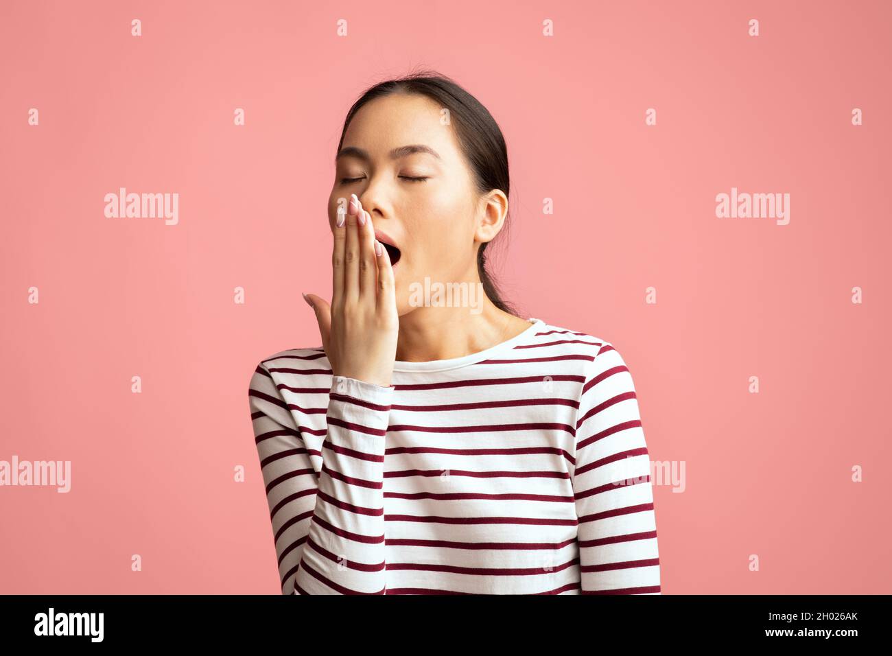 Yawning woman covering mouth hand hi-res stock photography and images ...