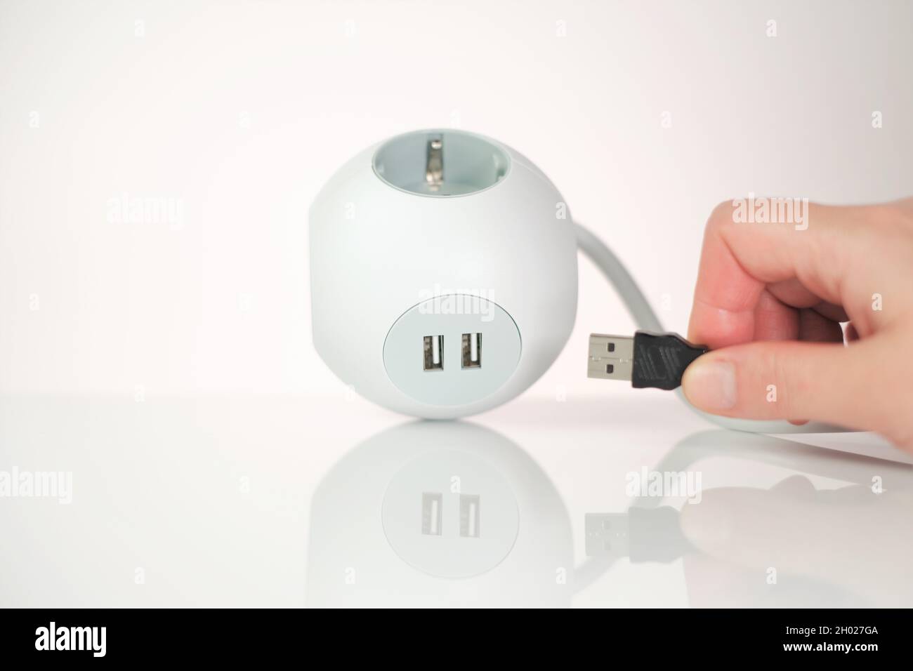 USB adapter.Socket with USB connector.charging station. Hands include ...